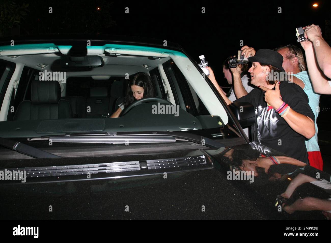 Courteney Cox smiles for photographers as she leaves one of her ...