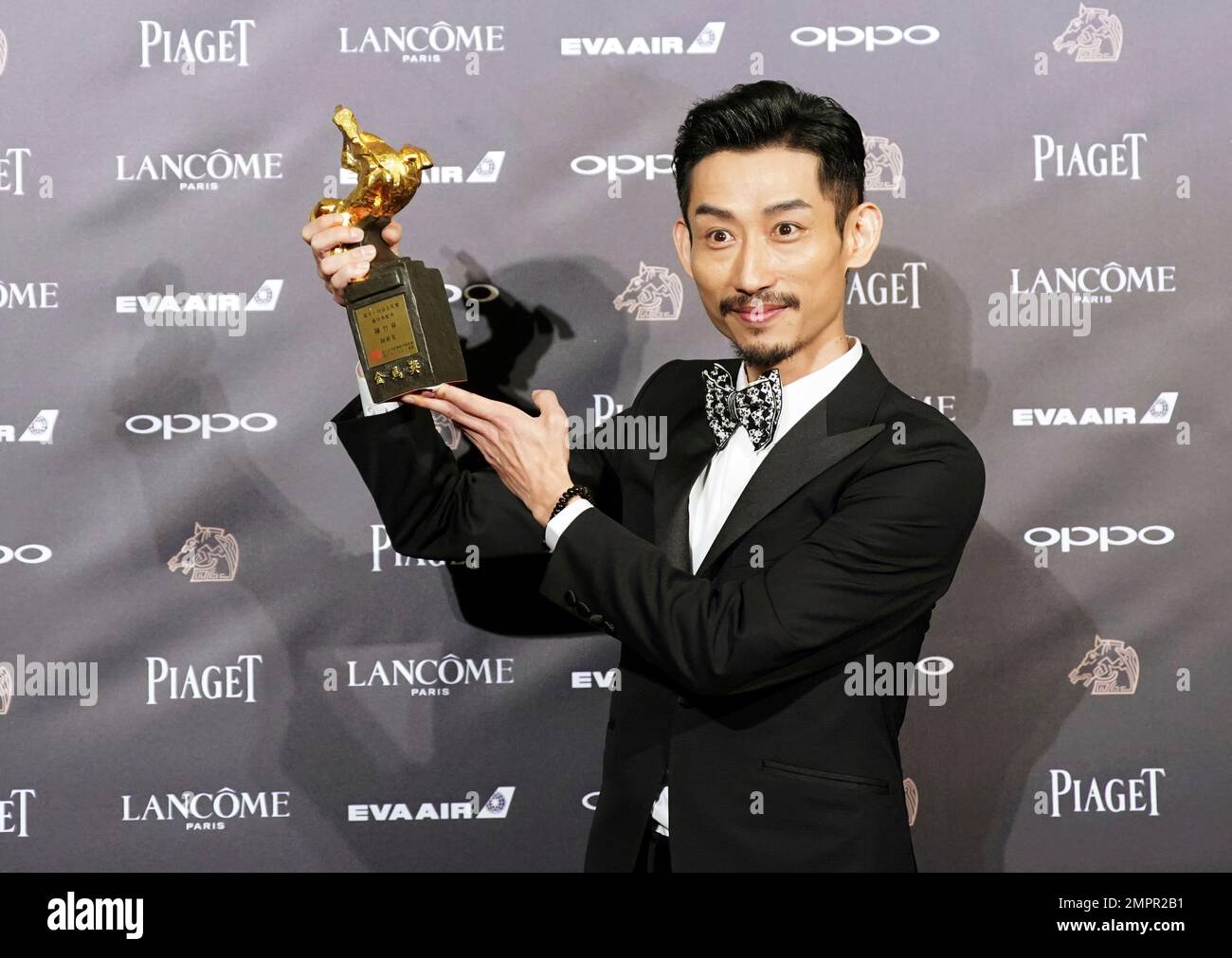 Taiwanese actor Bamboo Chen holds his awards and poses for media for ...