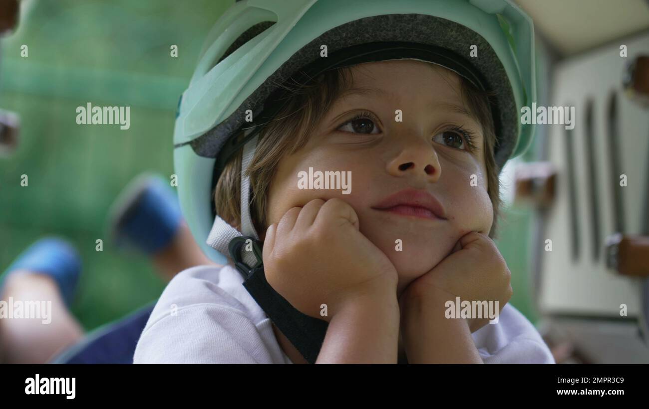 Portrait of a pensive child thinking with hands in chin with dreamy ...