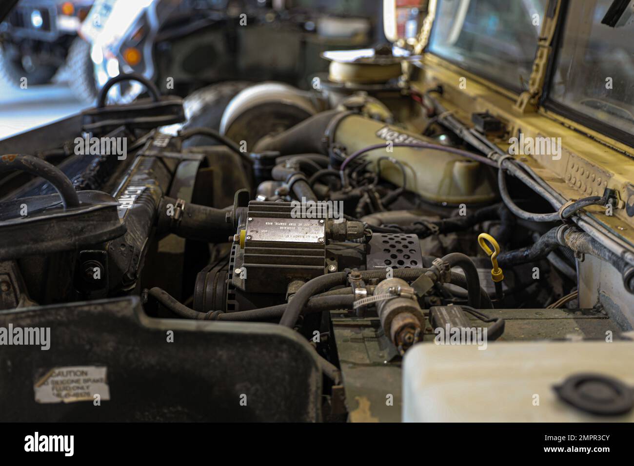 An engine rests under the hood of a High Mobility Multipurpose Wheeled ...