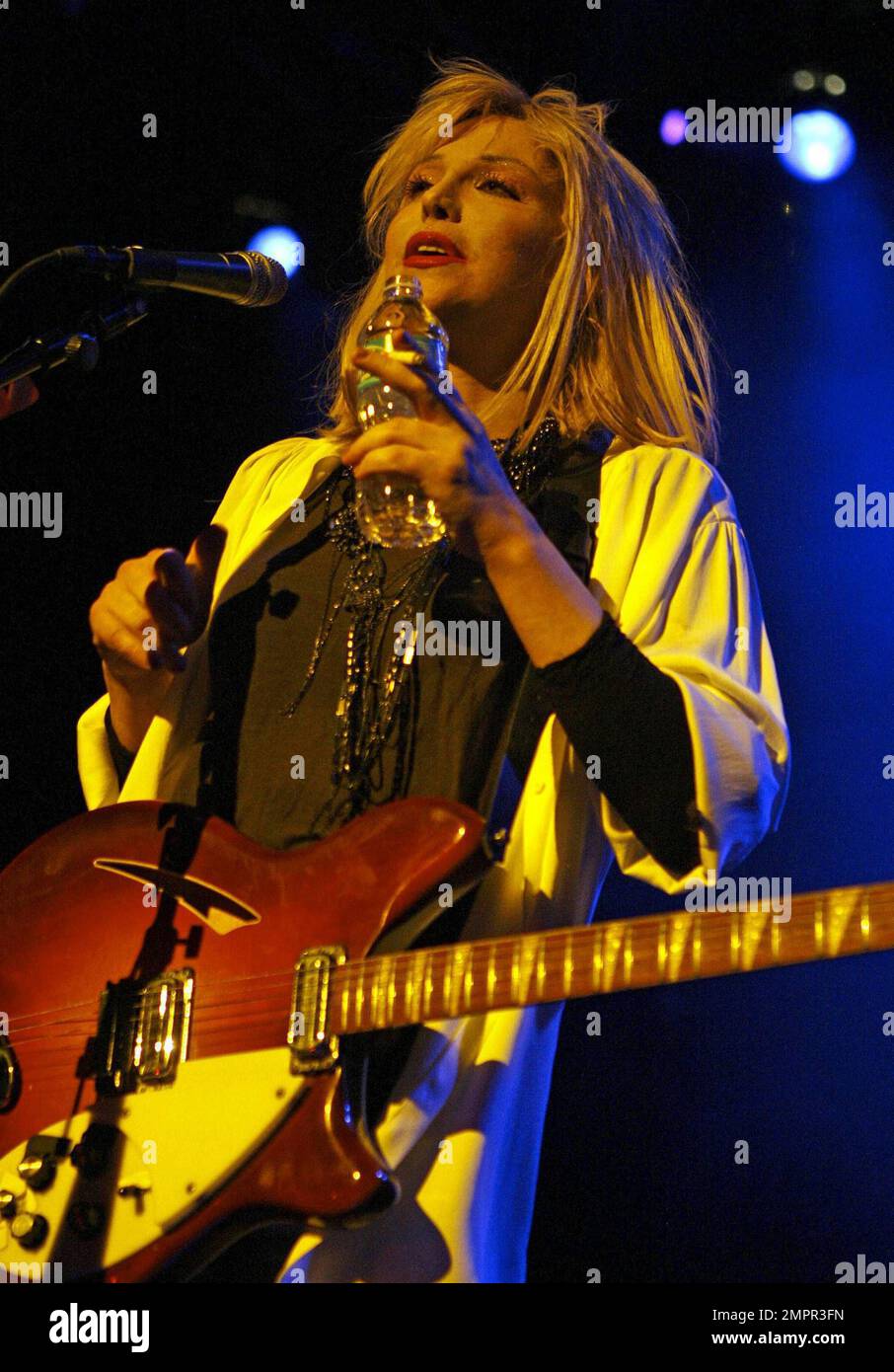 Courtney Love smokes a cigarette on stage as she performs live in ...