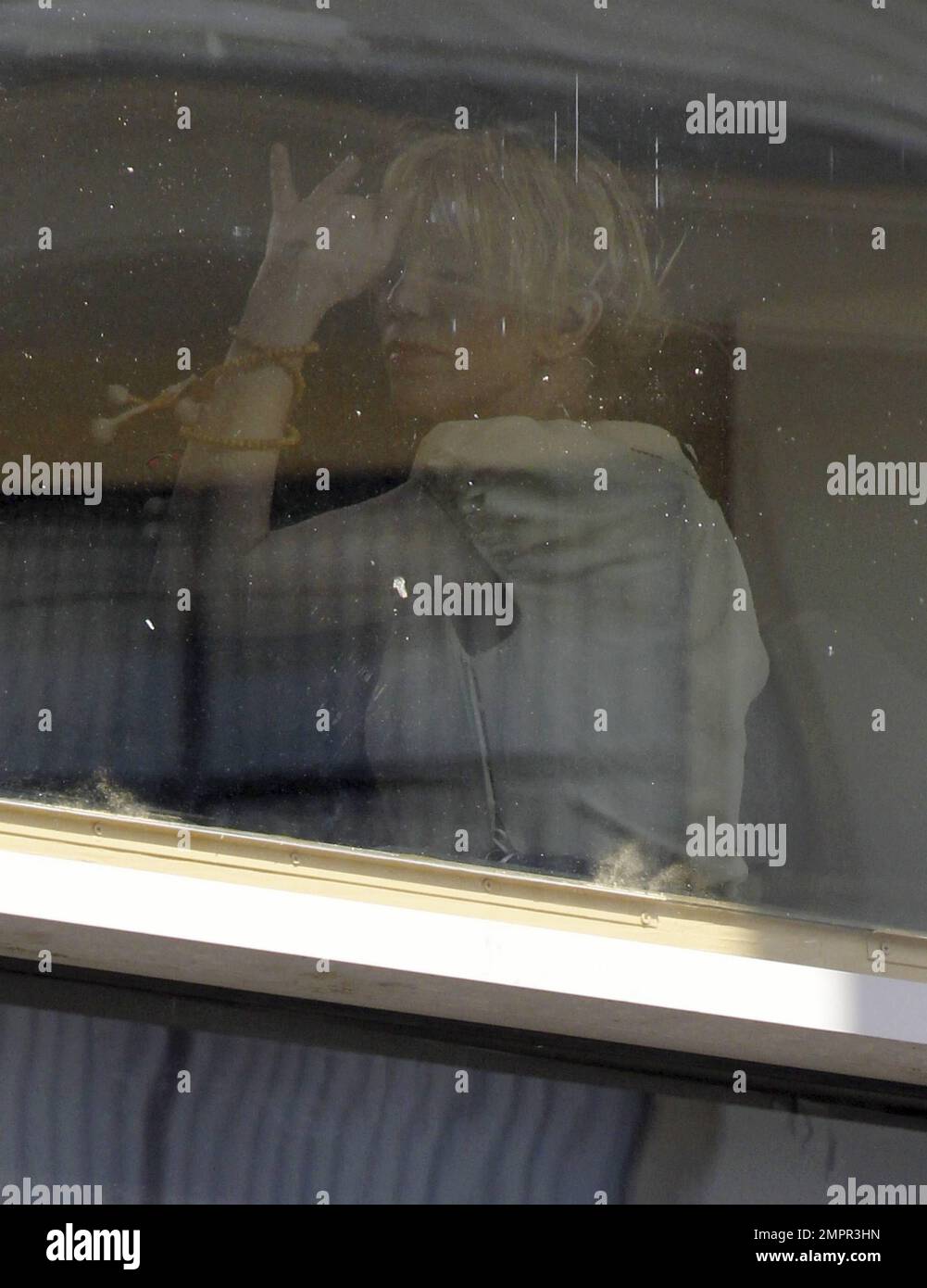 Courtney Love covers her face with her hands during what looks to be a ...
