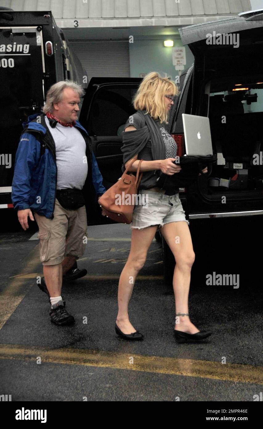 EXCLUSIVE!! Courtney Love is greeted by dogs as arrives in the rain ...