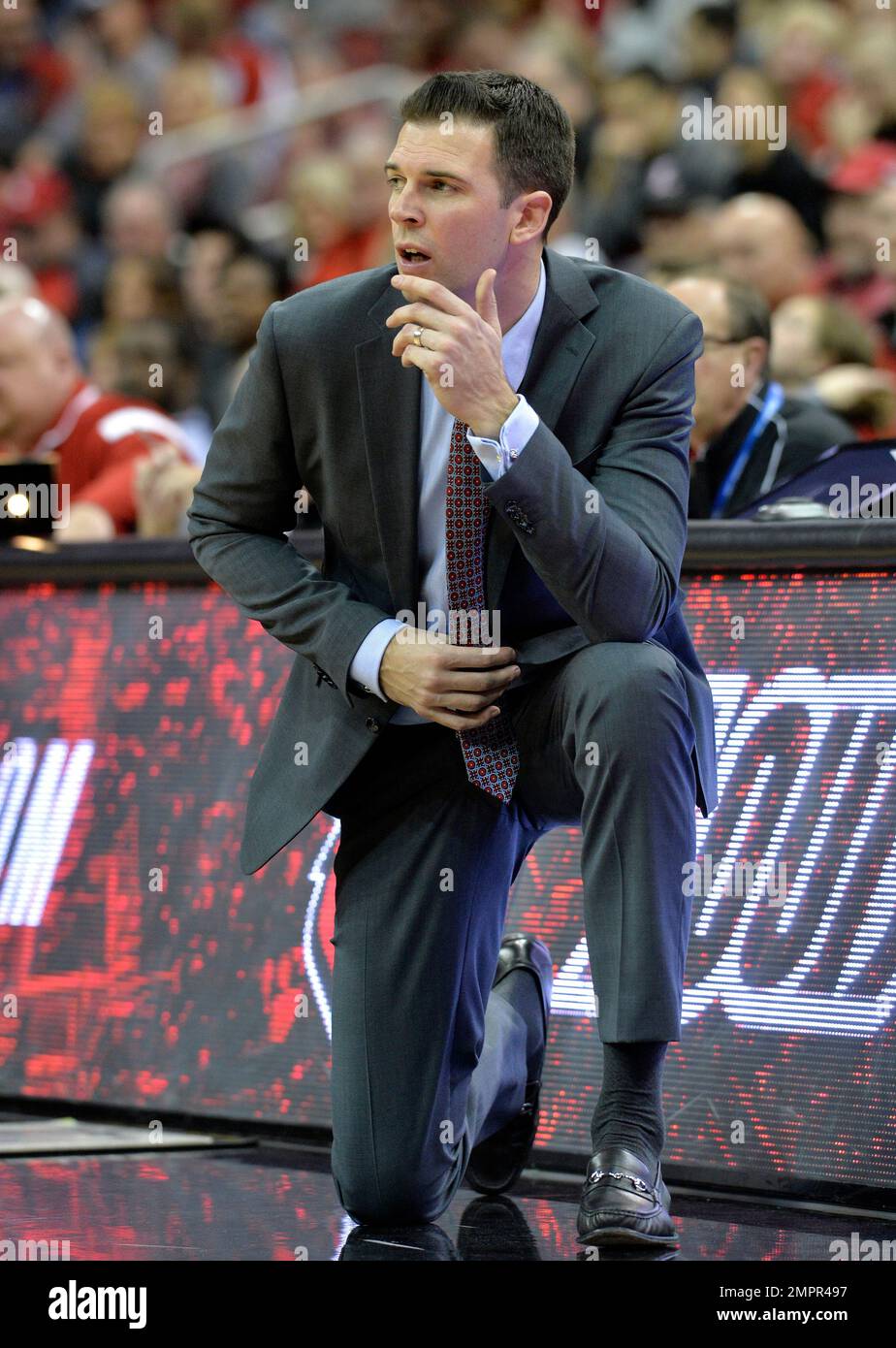 Louisville interim head coach David Padgett talks to his team during ...
