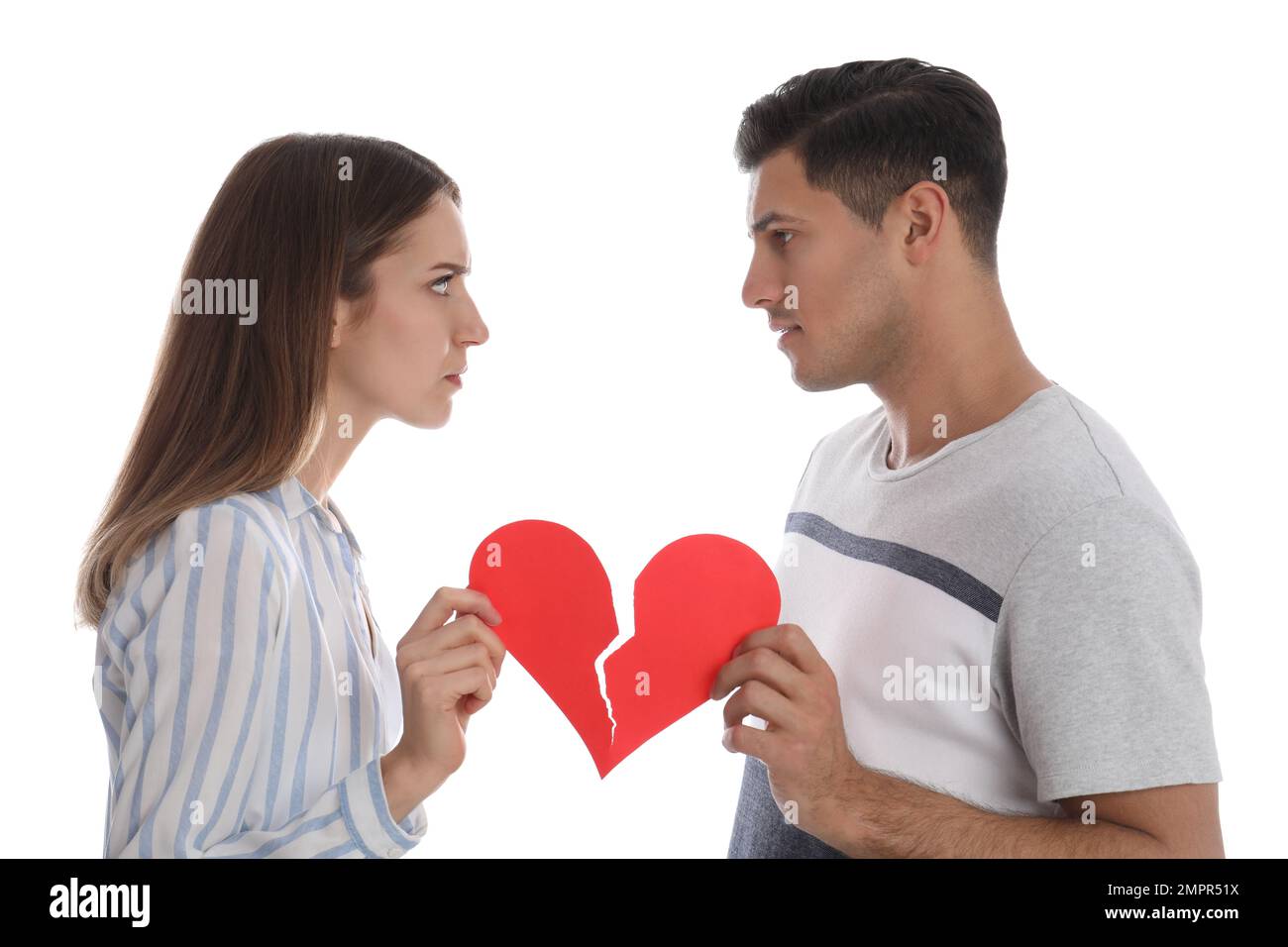 Couple with torn paper heart on white background. Relationship problems ...