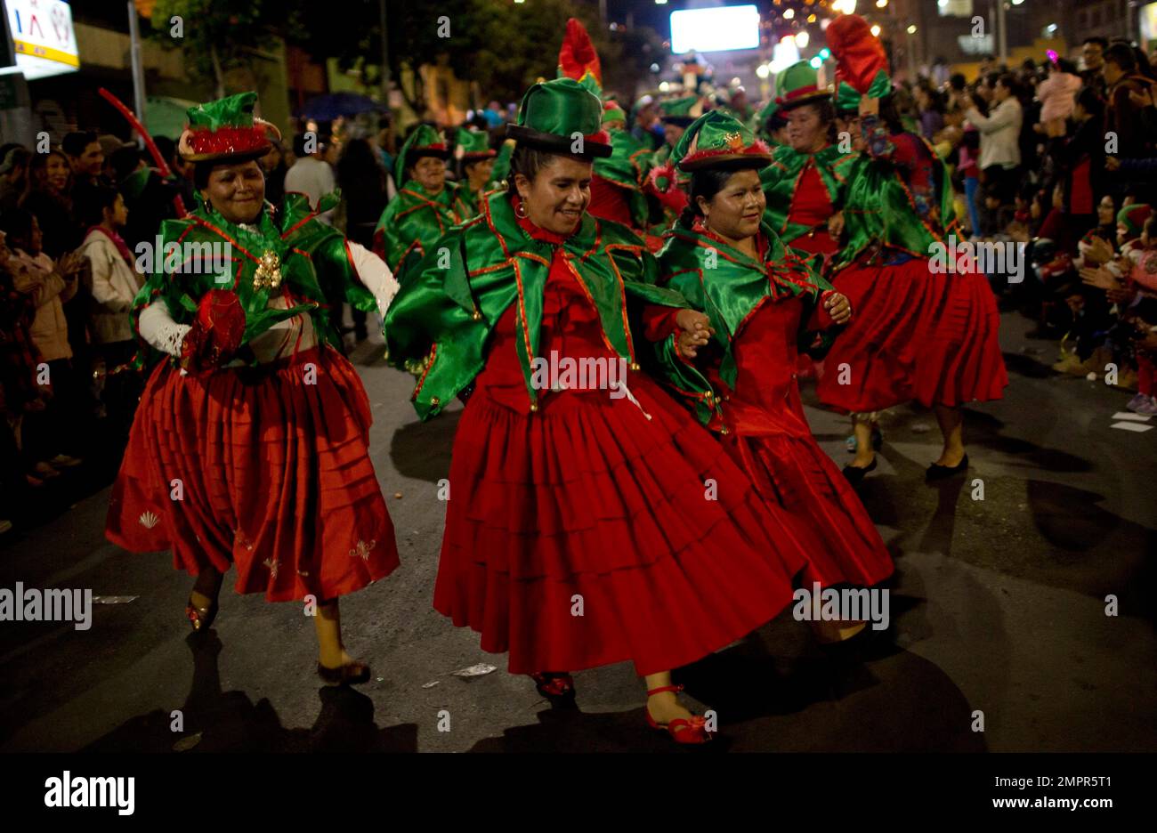 Women dressed as Christmas elves dance in the annual Christmas Parade ...