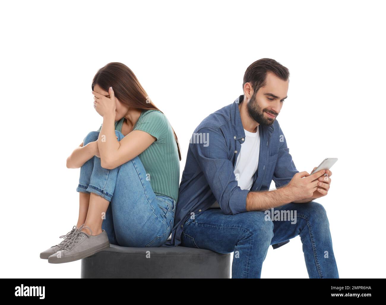 Man with smartphone ignoring his girlfriend on white background ...