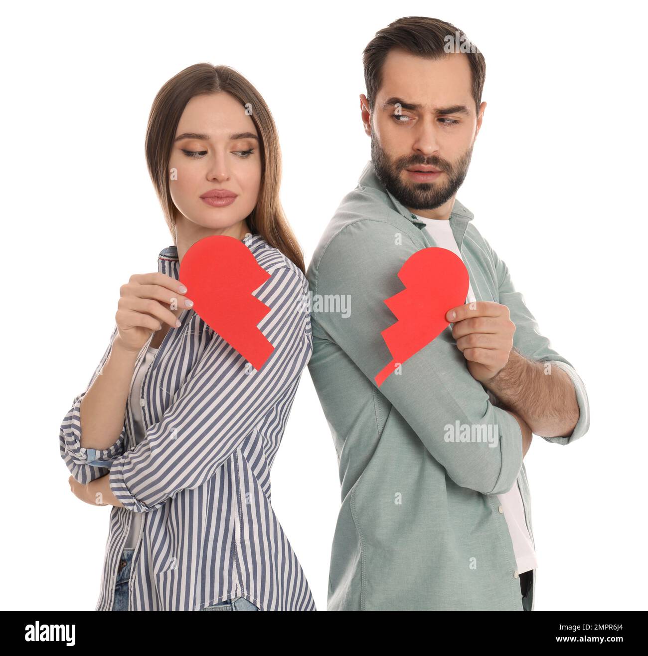 Couple with torn paper heart on white background. Relationship problems ...
