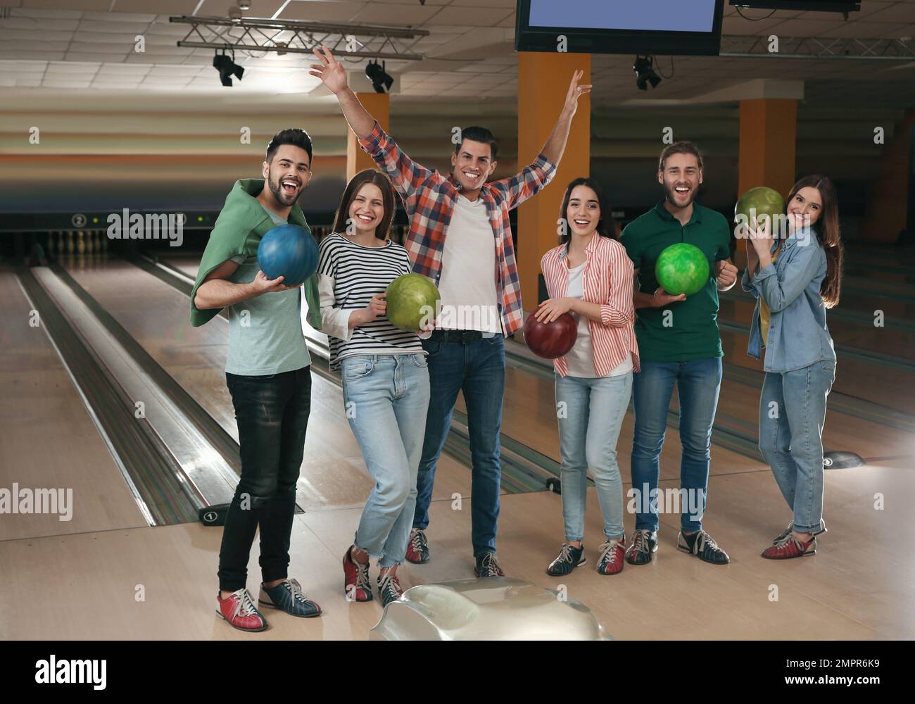 Group of friends with balls in bowling club Stock Photo - Alamy