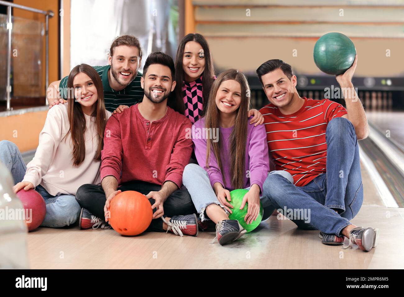 Group of friends with balls in bowling club Stock Photo - Alamy