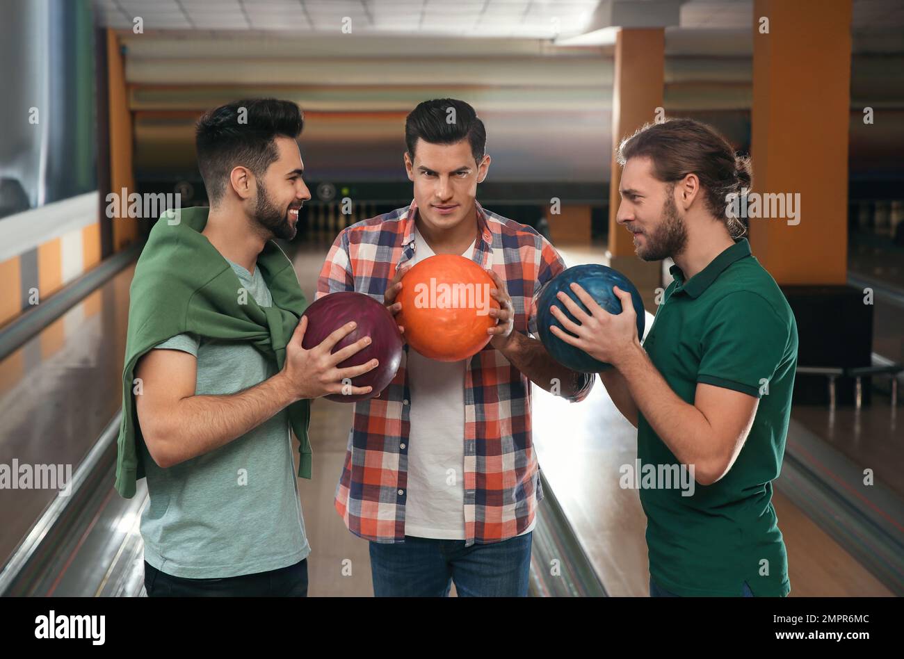 Group of men with balls in bowling club Stock Photo - Alamy