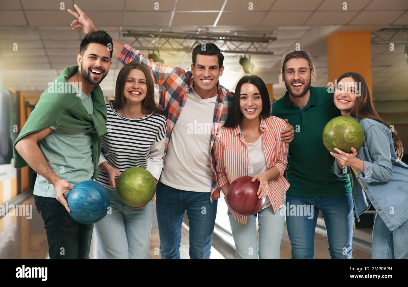 Group of friends with balls in bowling club Stock Photo - Alamy
