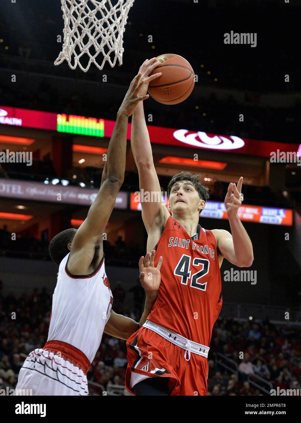 Saint Francis forward Mark Flagg (42) is fouled by Louisville forward V ...