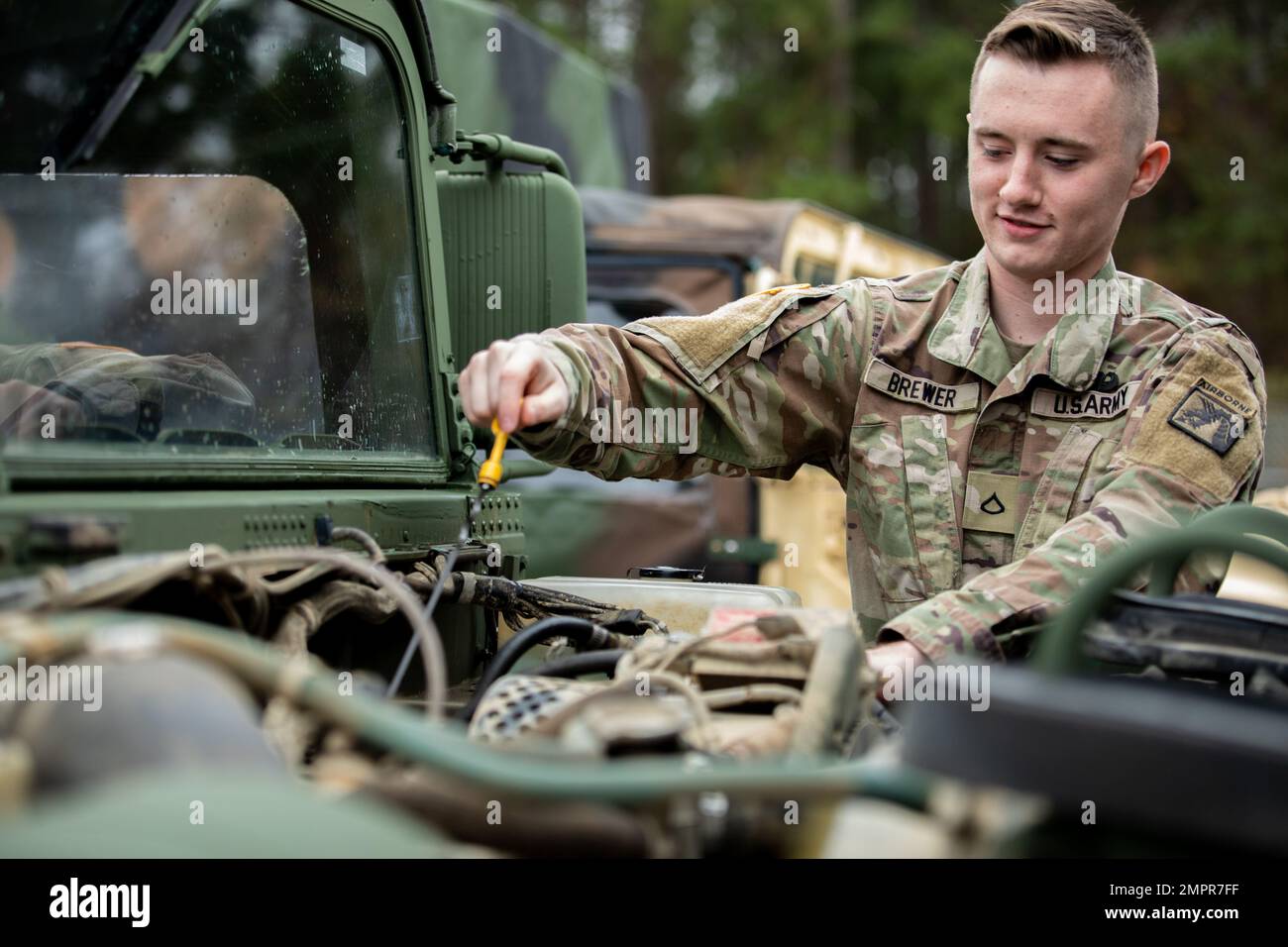 U.S. Army Pfc. Nolan Brewer from the 22nd Mobile Public Affairs Detachment checking the oil ...
