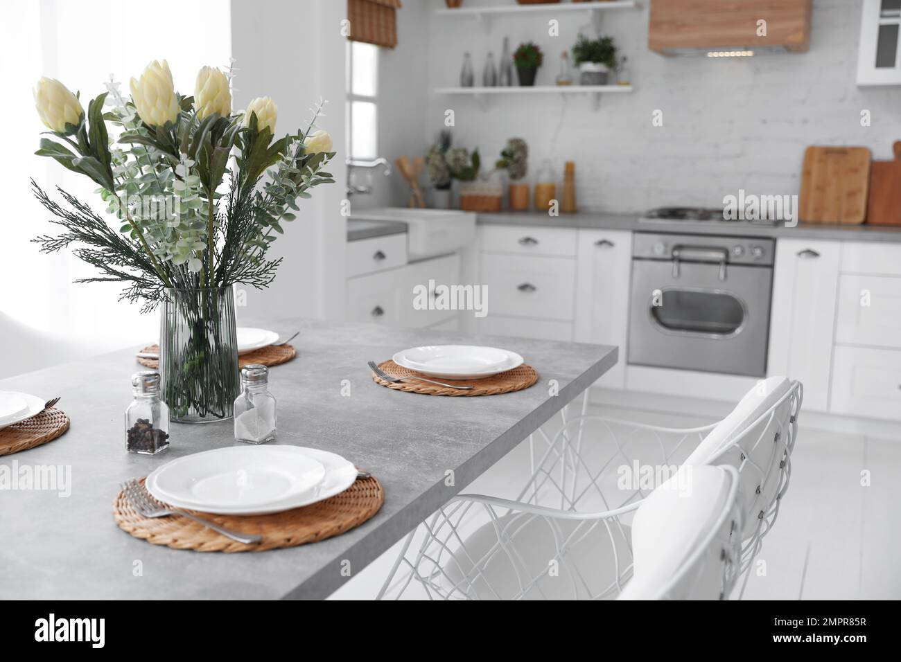 Elegant table setting in stylish kitchen. Interior design Stock Photo ...