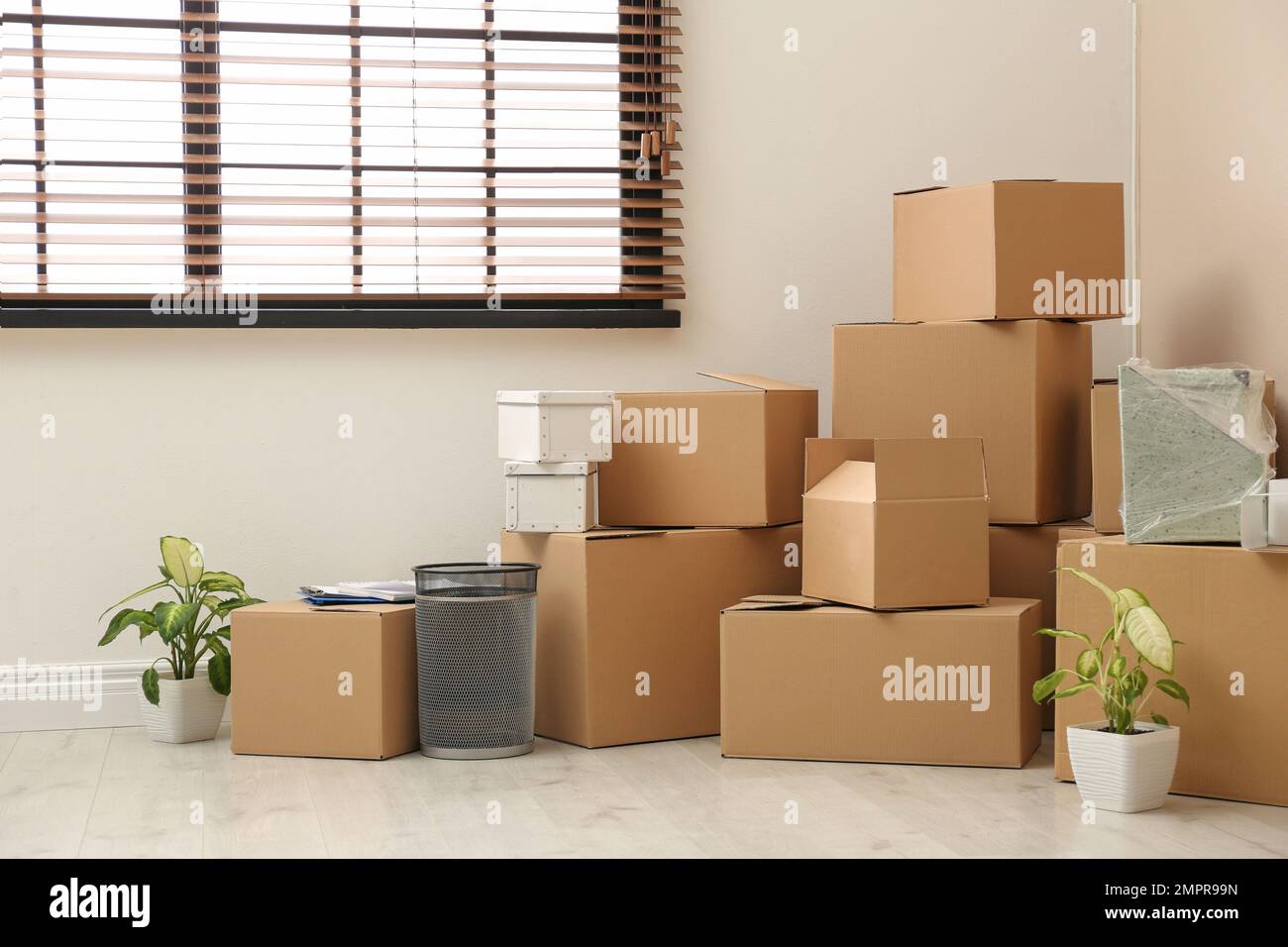 Moving boxes and stuff near window in room Stock Photo - Alamy