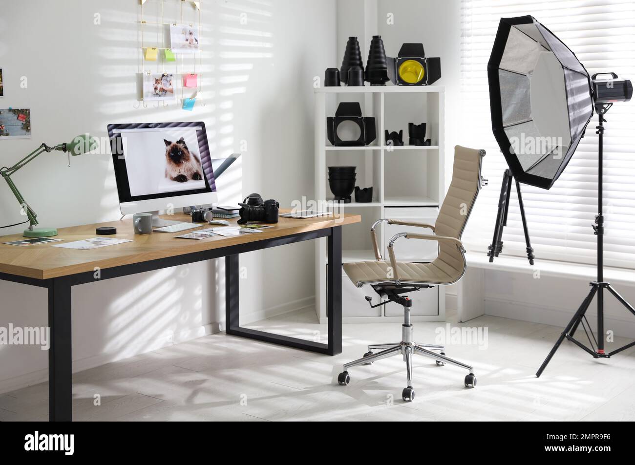 Photographer's workplace with professional camera and computer in ...