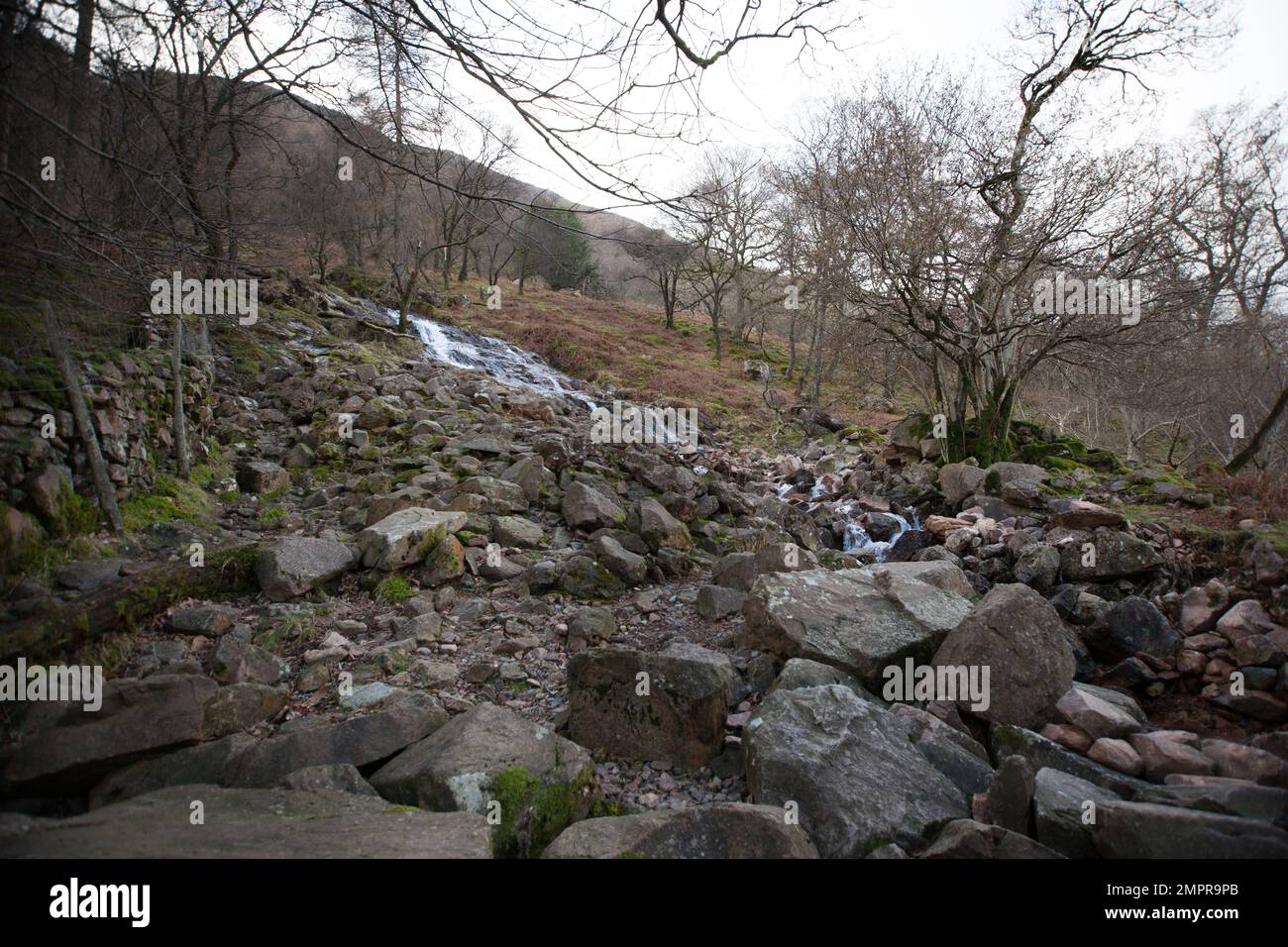 A waterfall flowing into Lake Buttermere, Cumbria in the UK Stock Photo ...