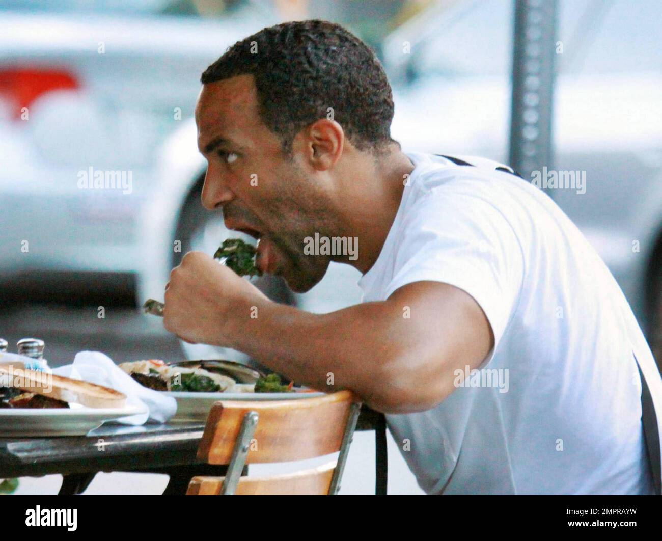 EXCLUSIVE!! British R&B singer Craig David tucks in to his lunch at an outdoor restaurant on ...
