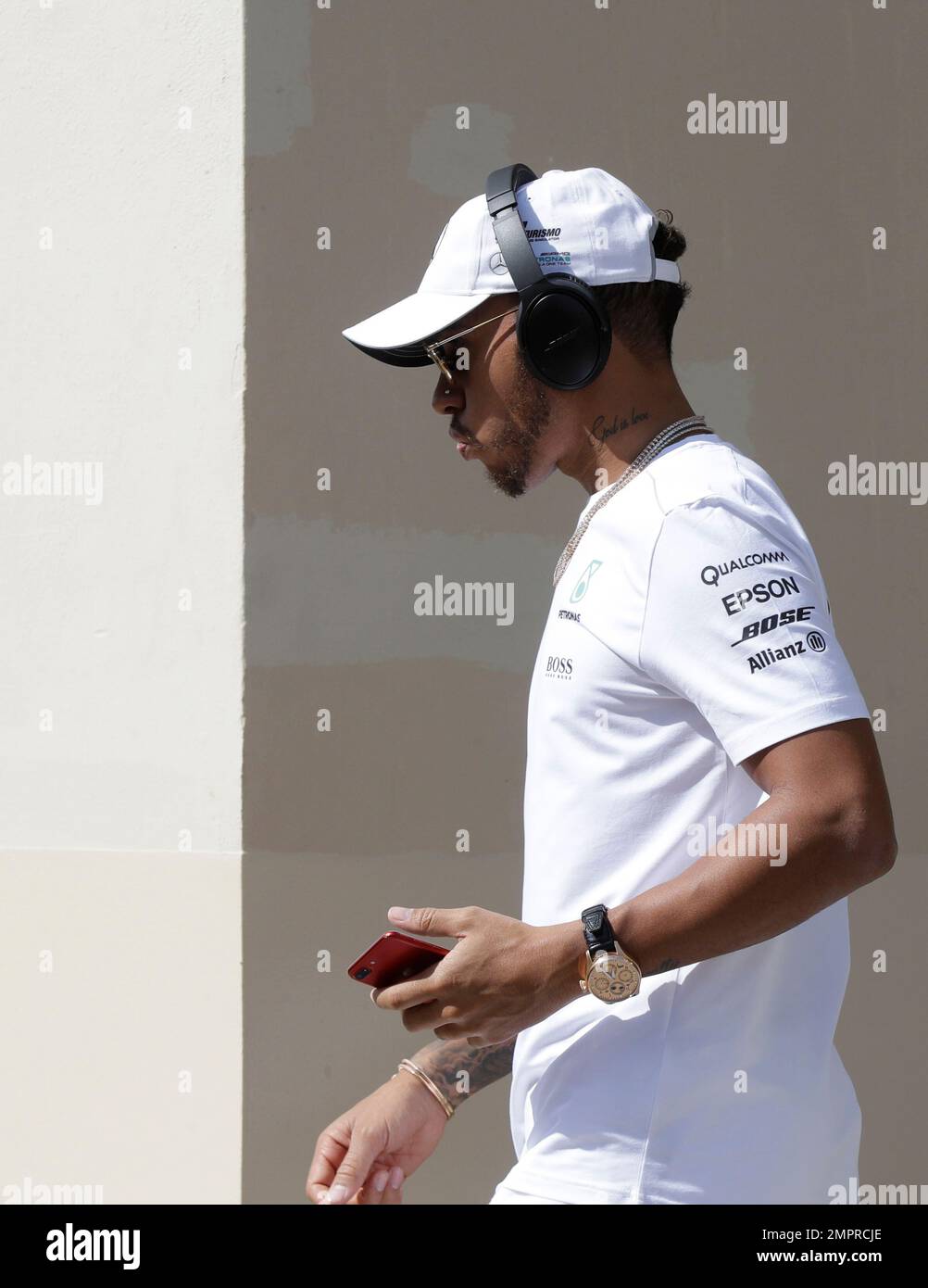 Mercedes driver Lewis Hamilton of Britain walks in the paddock before ...