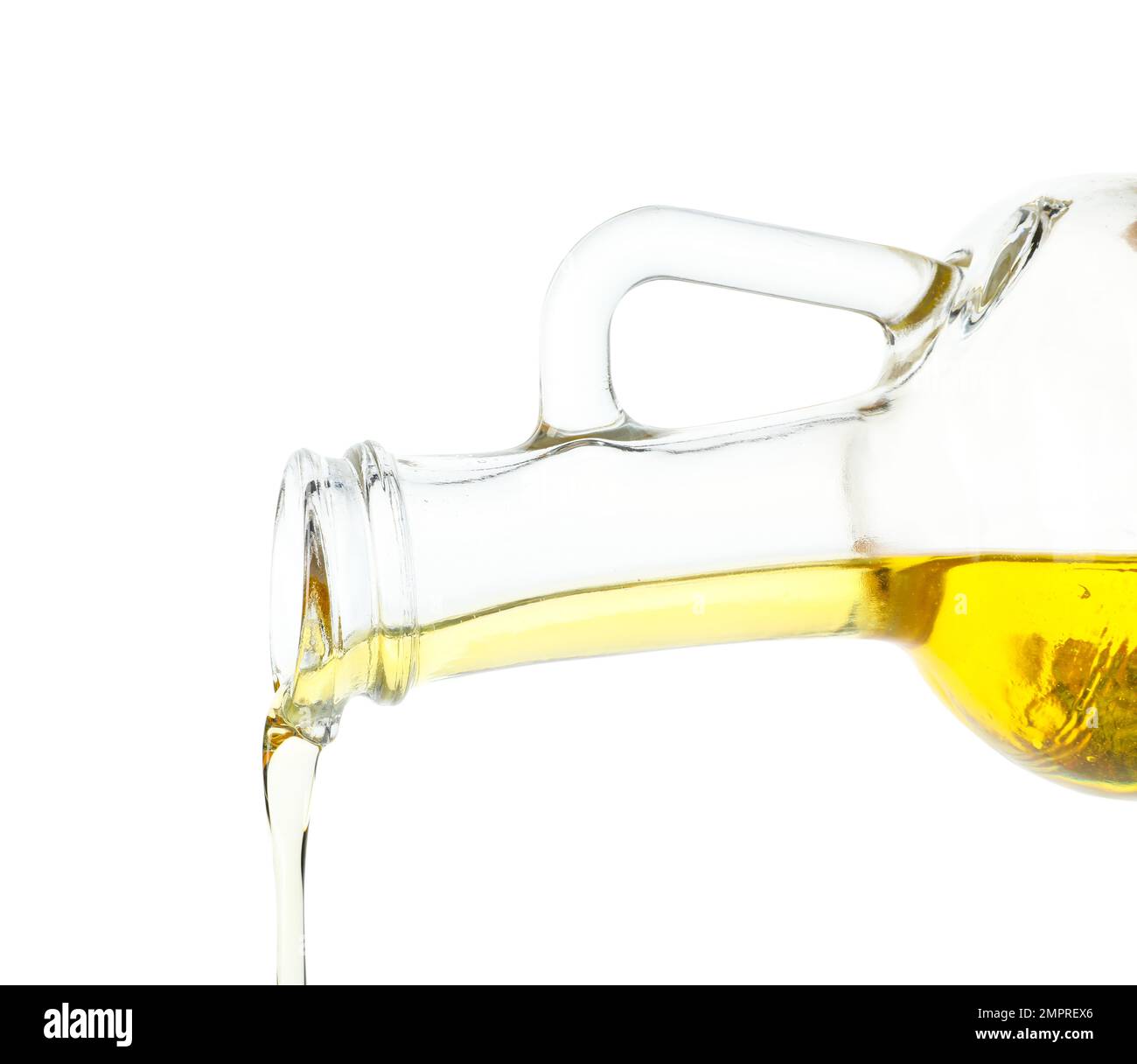 Pouring cooking oil from pitcher isolated on white Stock Photo - Alamy