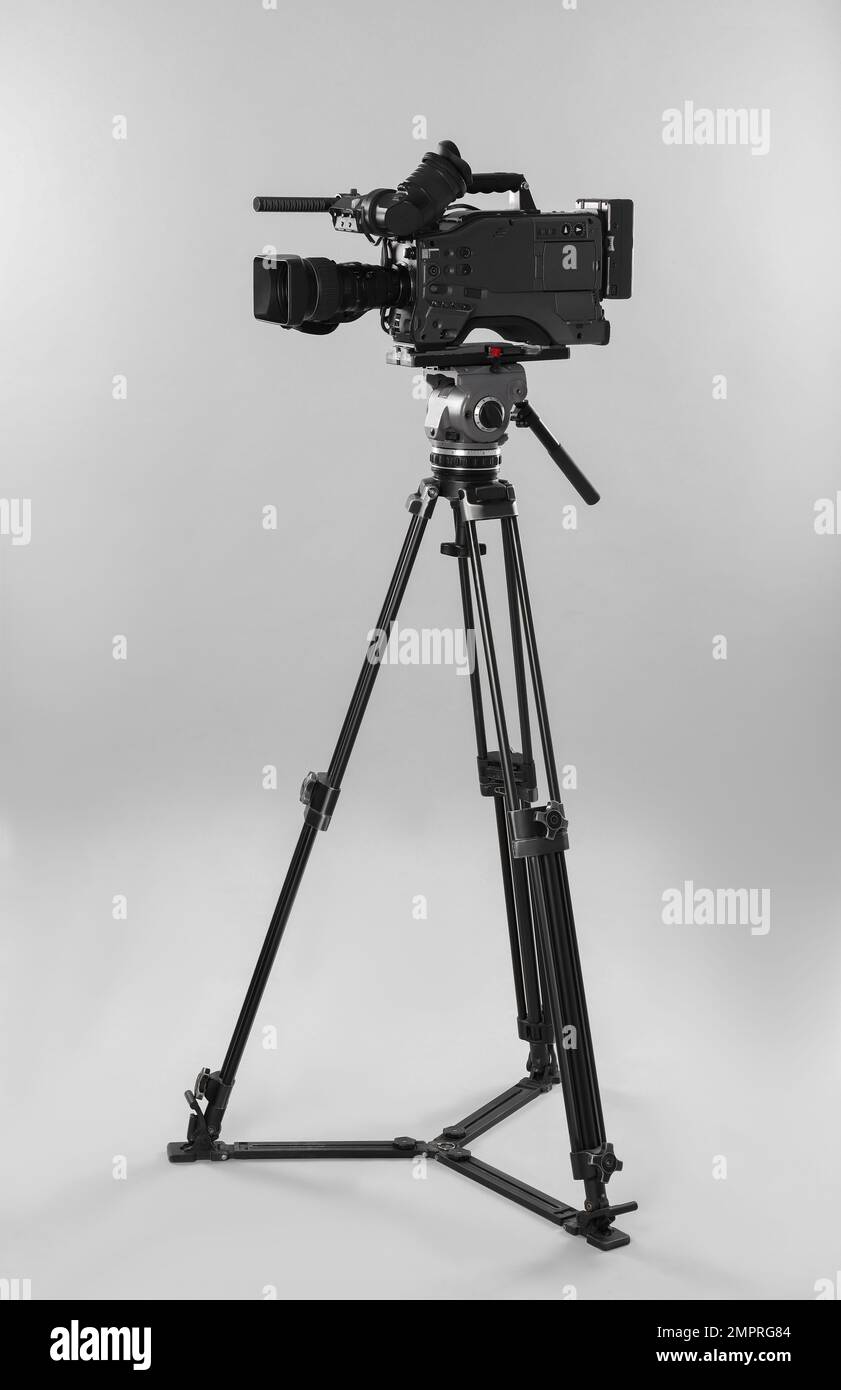 Modern professional video camera on light background Stock Photo - Alamy