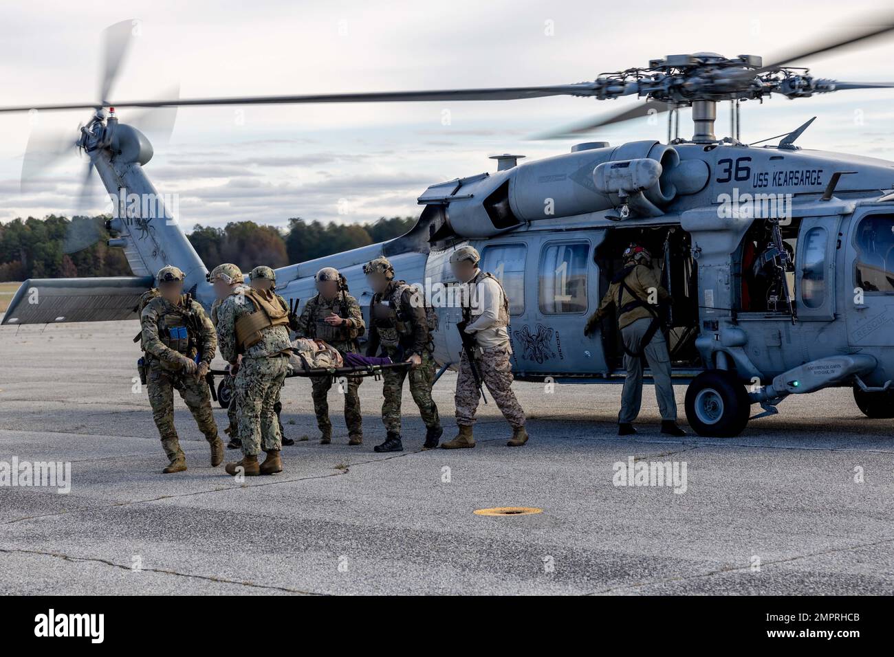 U.S. Navy SEALs exit an MH-60S Seahawk assigned to Helicopter Sea ...