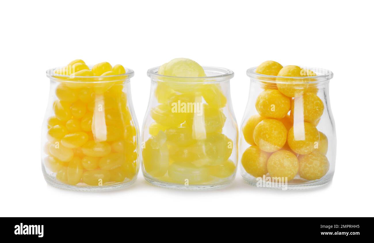 Different tasty lemon drops in jars isolated on white Stock Photo - Alamy