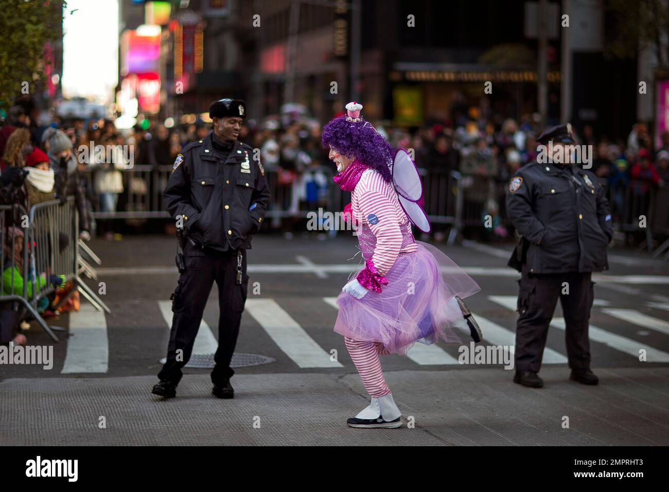 Police stand guard as a clown passes by during the Macy's Thanksgiving ...