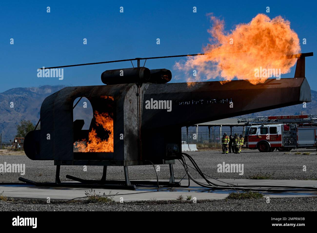 A mock helicopter emits a burst of flames during a fire training ...