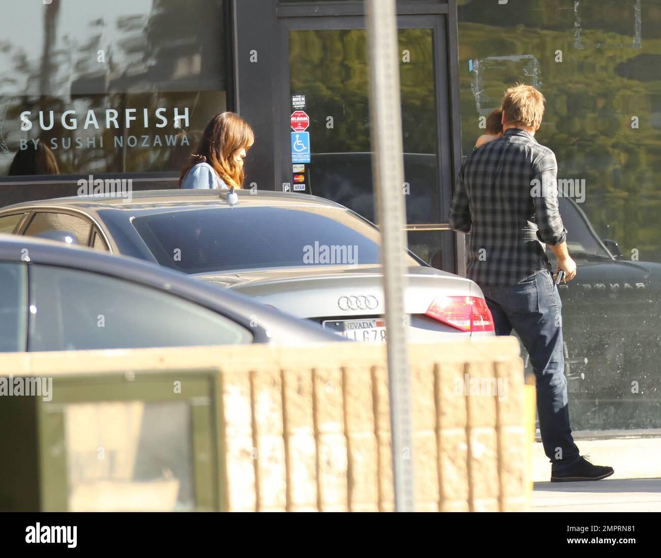 Australian celebrity chef, Curtis Stone, carries his son Hudson to the ...