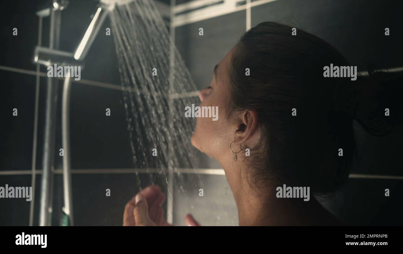Woman washing face inside shower bath. Female person daily hygiene ...