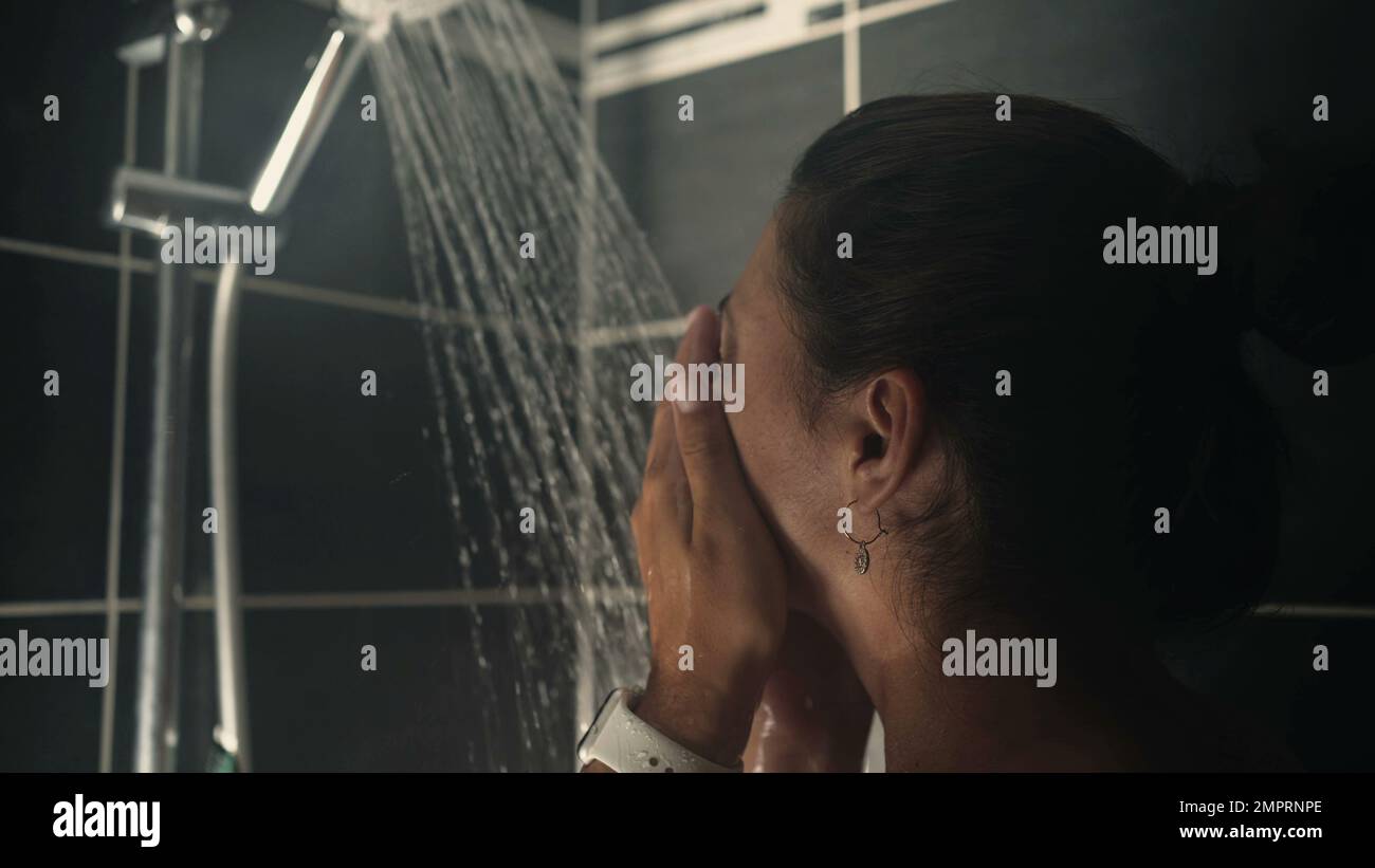 Woman washing face inside shower bath. Female person daily hygiene ...