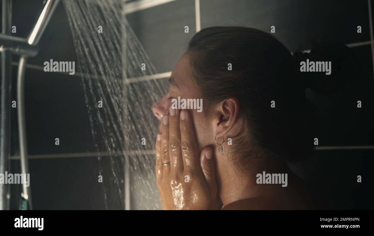 Woman washing face inside shower bath. Female person daily hygiene ...
