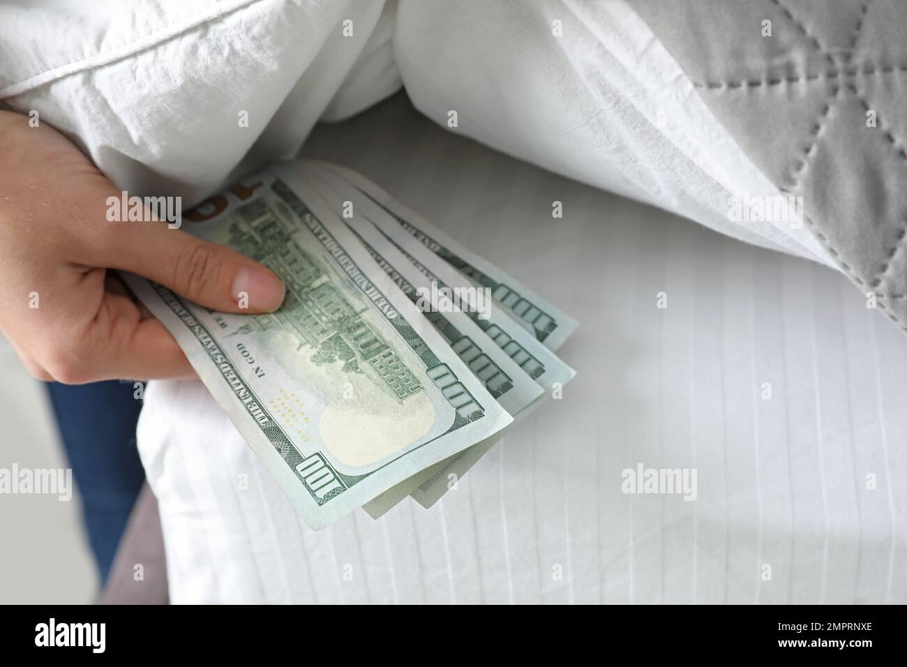 Woman hiding money bed hi-res stock photography and images - Alamy