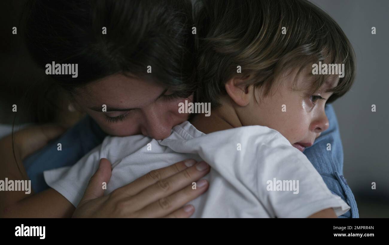 Mother hugging and caressing child back. Parent consoles crying small ...