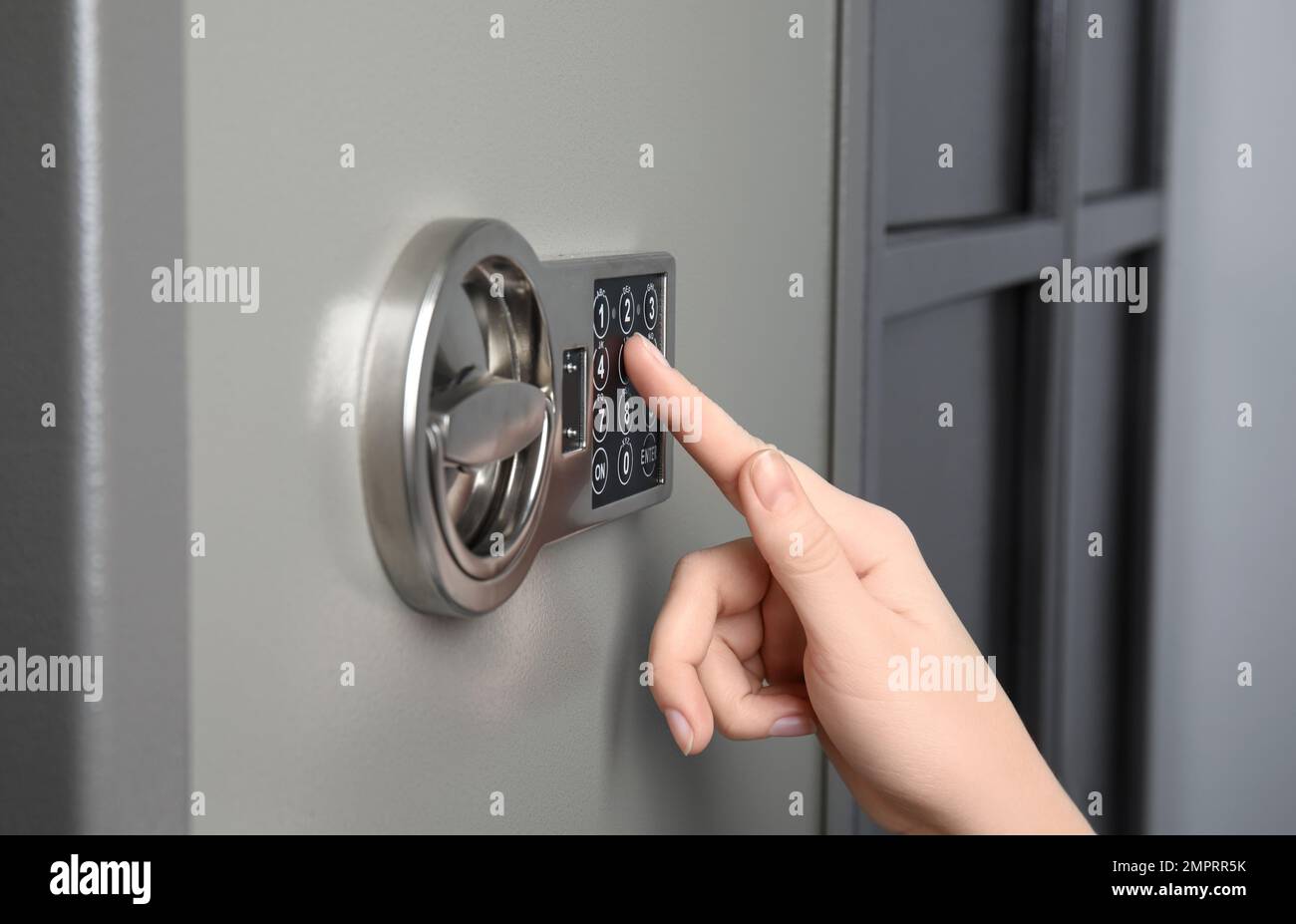 Woman opening steel safe with electronic lock, closeup Stock Photo - Alamy