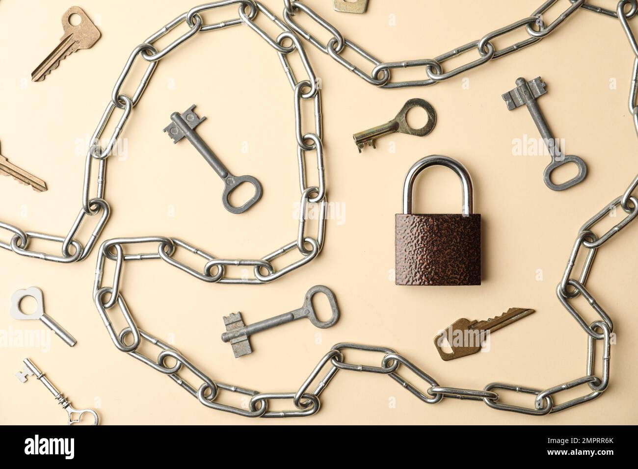 Steel padlock, keys and chain on beige background, flat lay. Safety ...