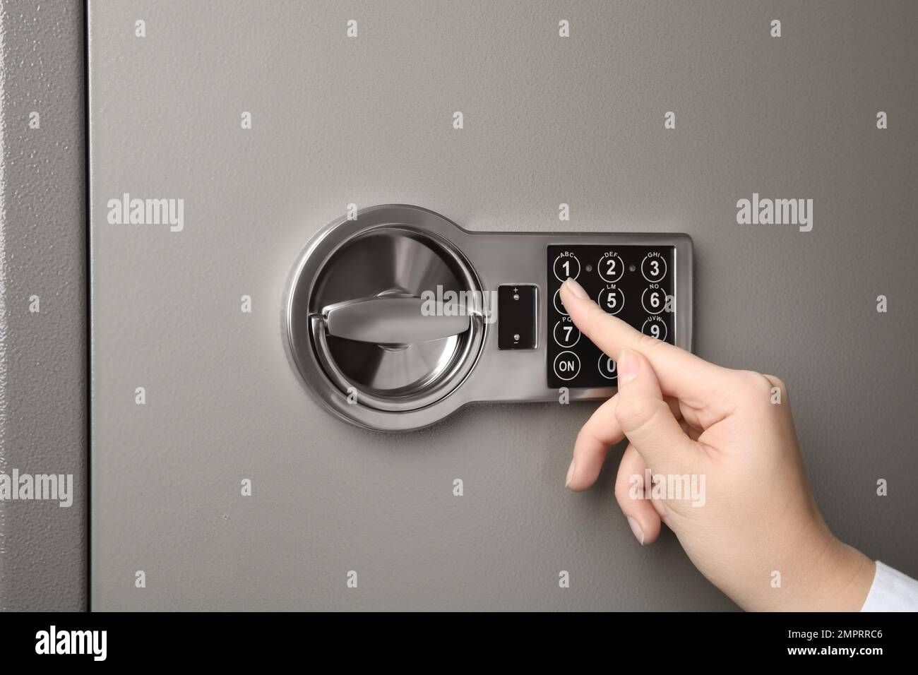 Woman opening steel safe hi-res stock photography and images - Alamy