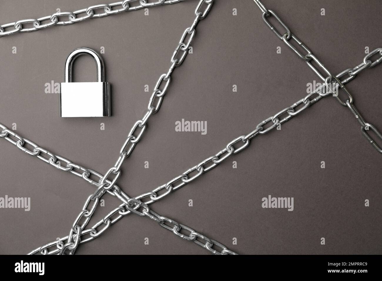 Steel padlock and chains on grey background, flat lay. Safety concept ...