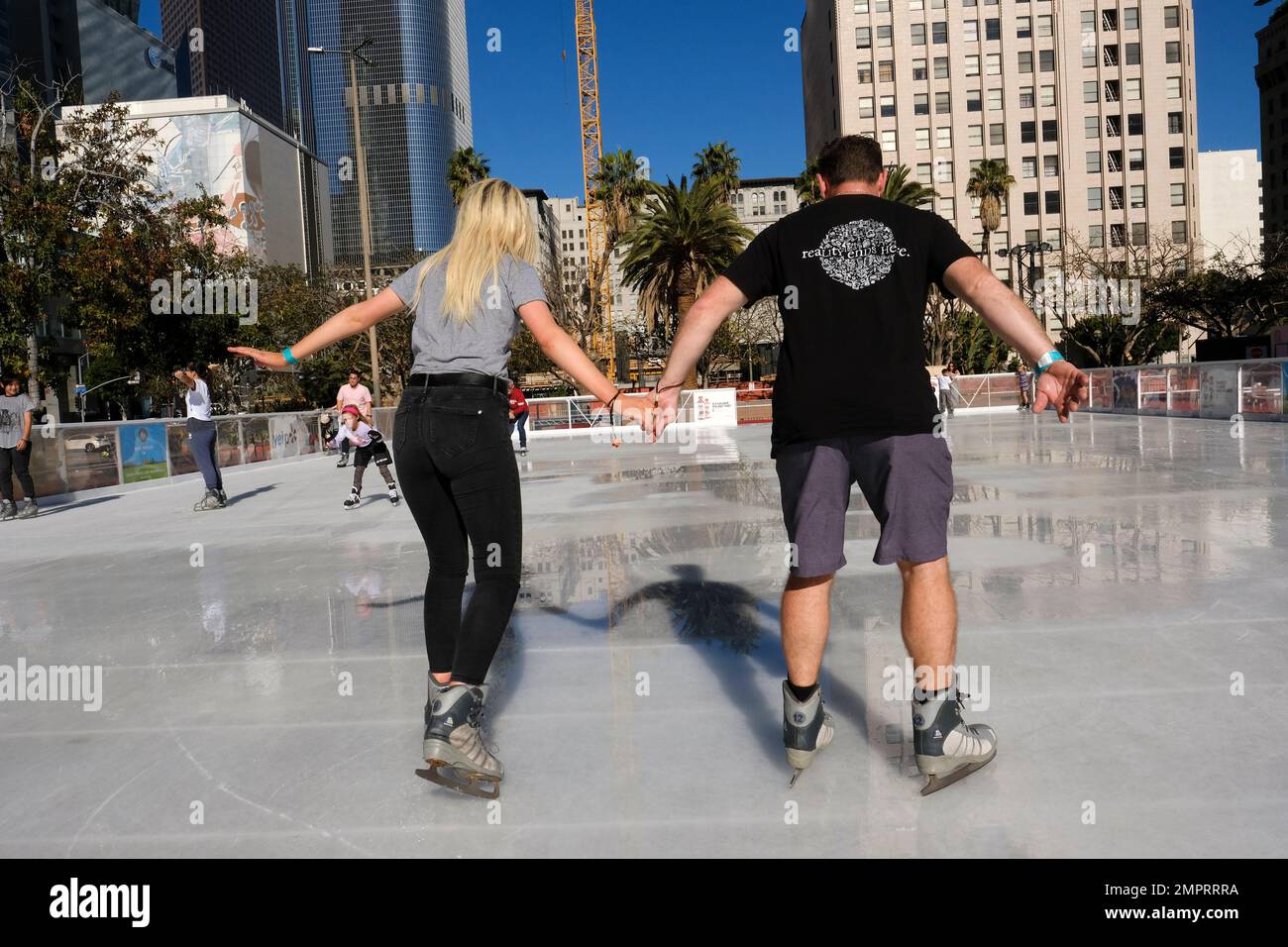 A couple carefully maneuver their way around the Holiday Ice Rink in ...