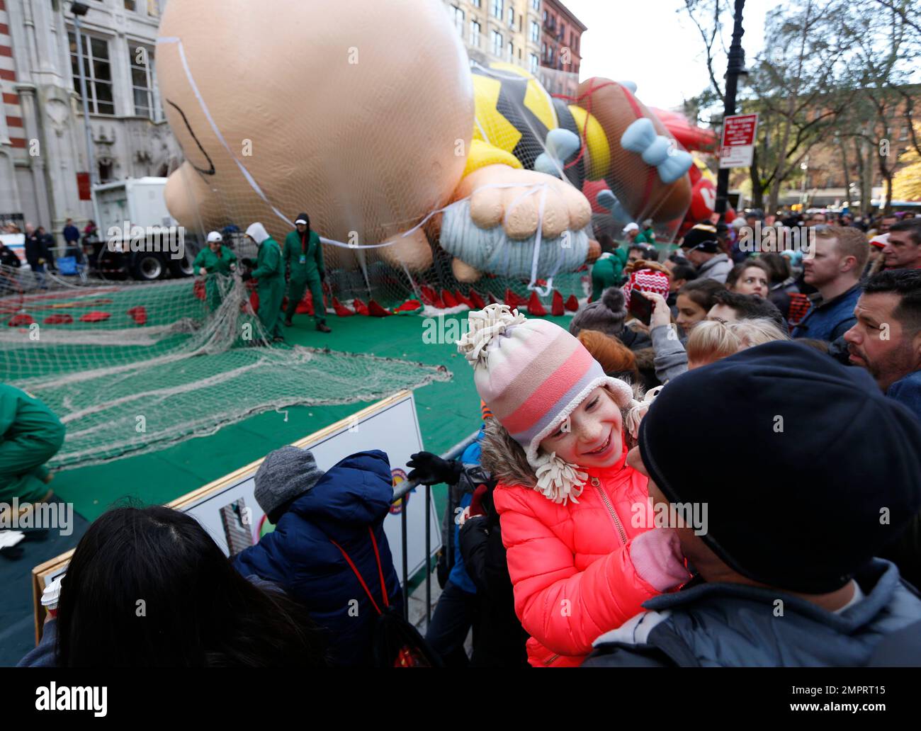 Emily Newman, 7, plays with her father as they watch the balloons being ...