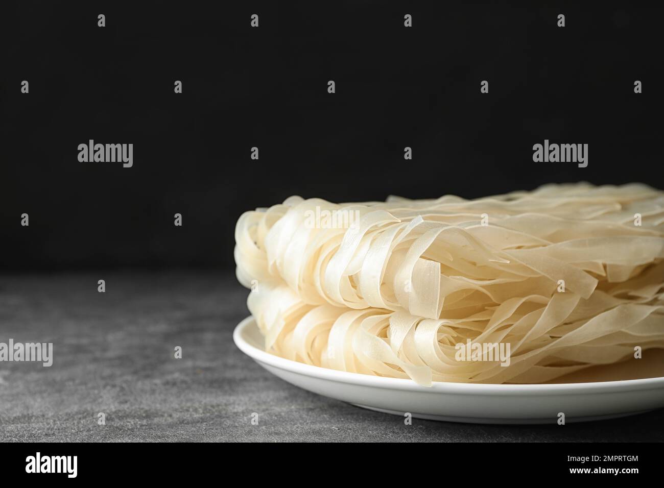 Block of rice noodles on grey table Stock Photo - Alamy