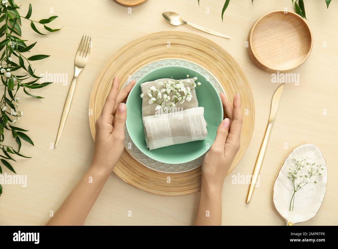 Woman setting table with flowers for festive dinner, top view Stock ...