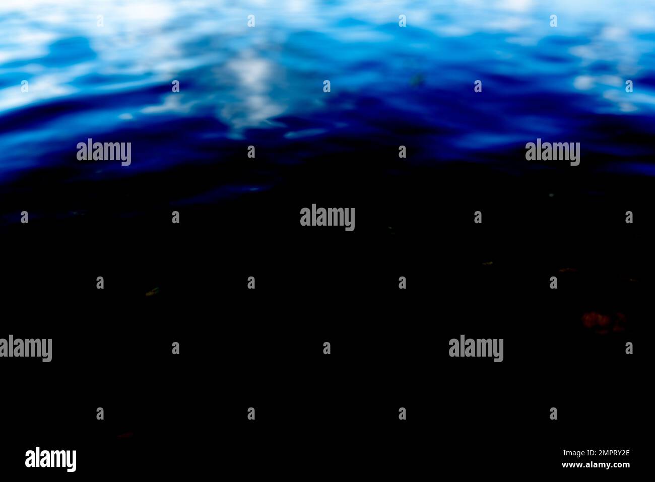 Abstract photo of the surface of the water with the reflection of dark ...