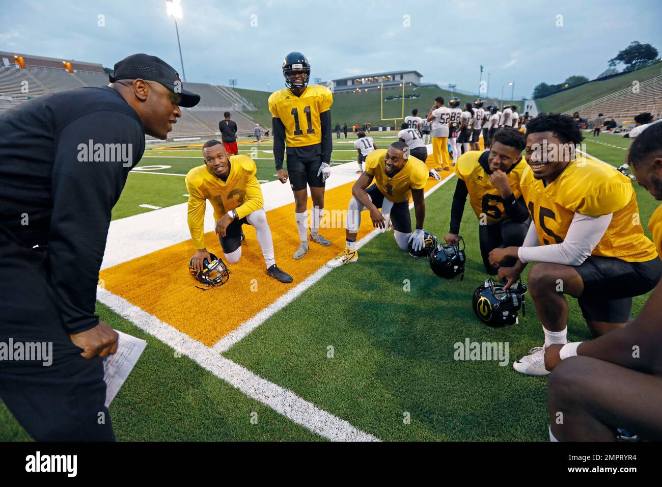 Grambling's quarterback coach Kendrick Nord, left, jokes with offensive ...