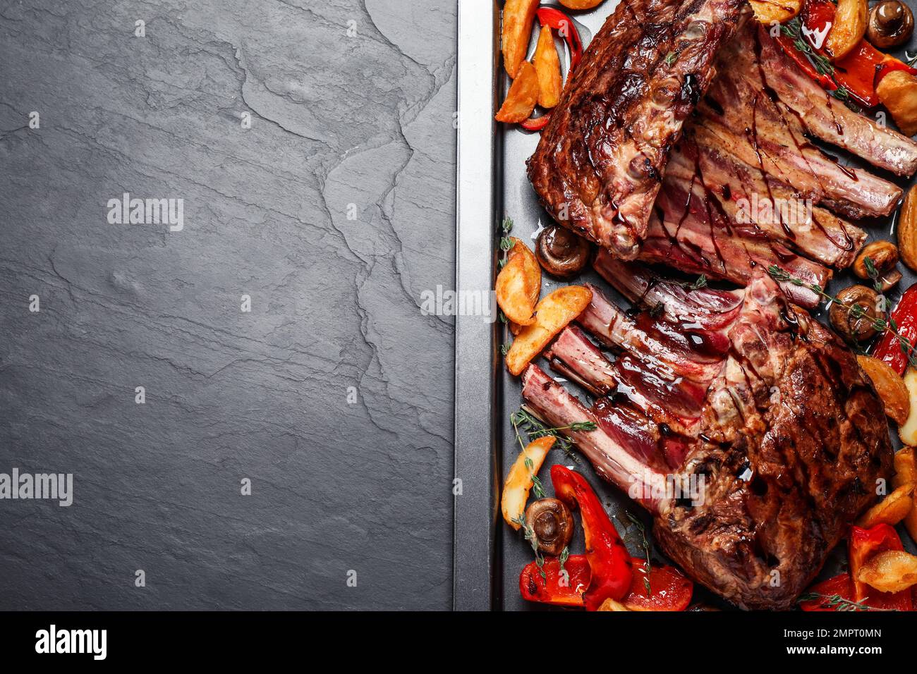 Delicious roasted ribs with garnish, top view. Space for text Stock ...
