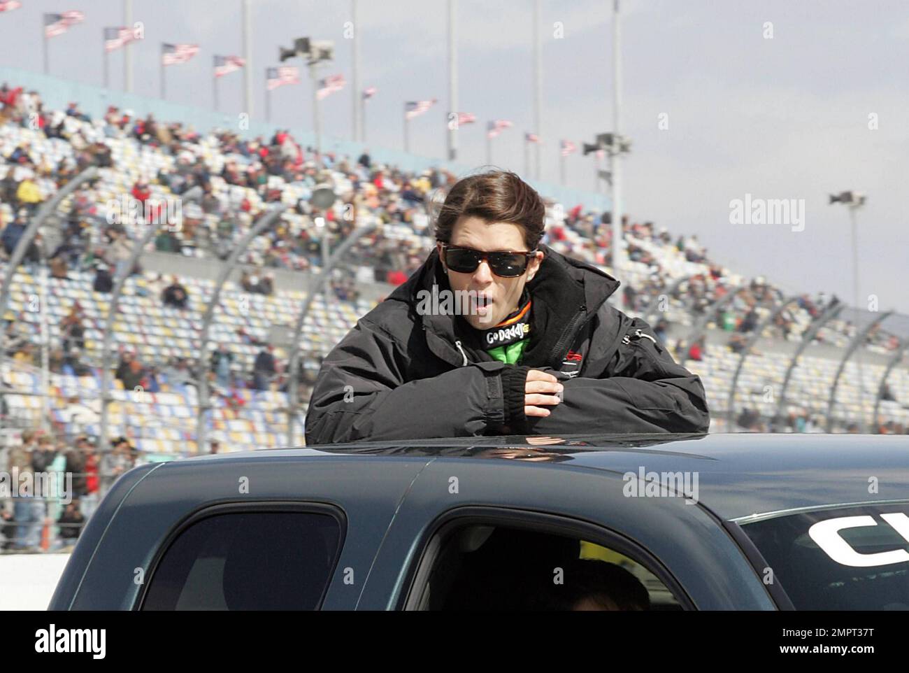 Danica Patrick walks out to her car on pit row for her NASCAR debut in ...