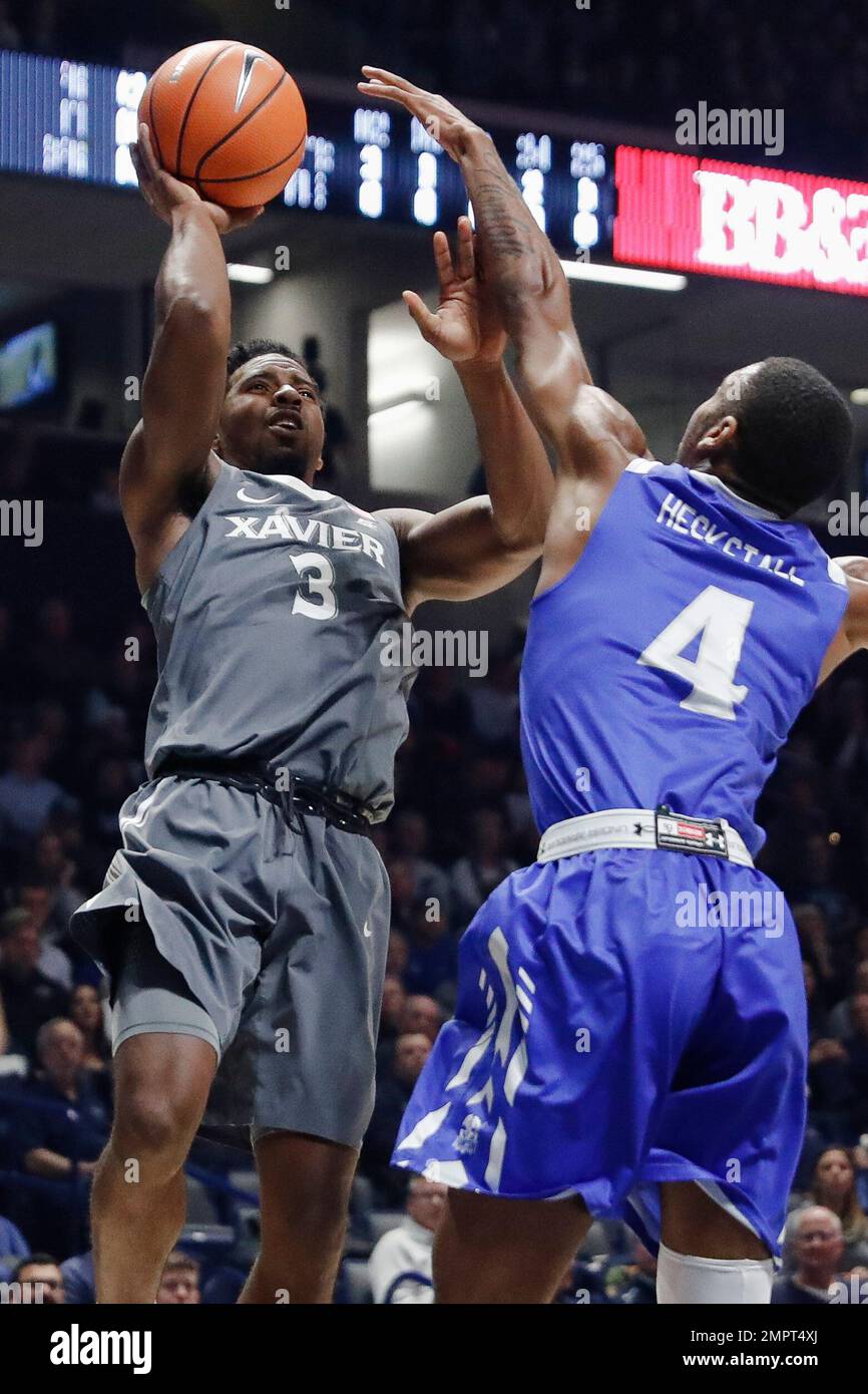 Xavier's Quentin Goodin (3) shoots over Hampton's Greg Heckstall (4) in ...