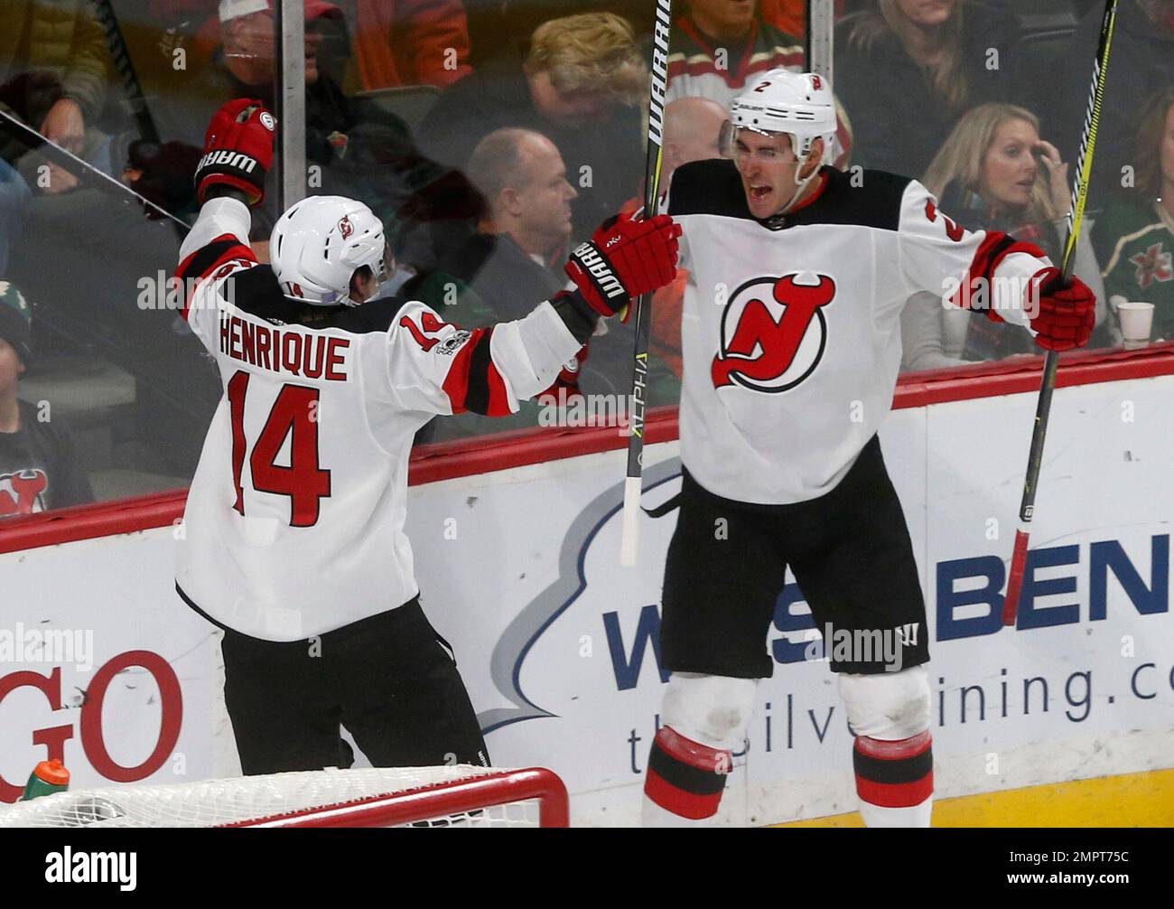 New Jersey Devils' John Moore, right, and Adam Henrique celebrate Moore ...